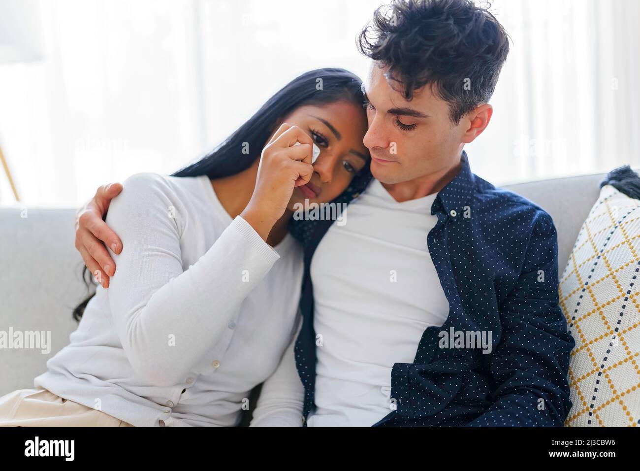 Woman crying in the arms of her boyfriend Stock Photo - Alamy