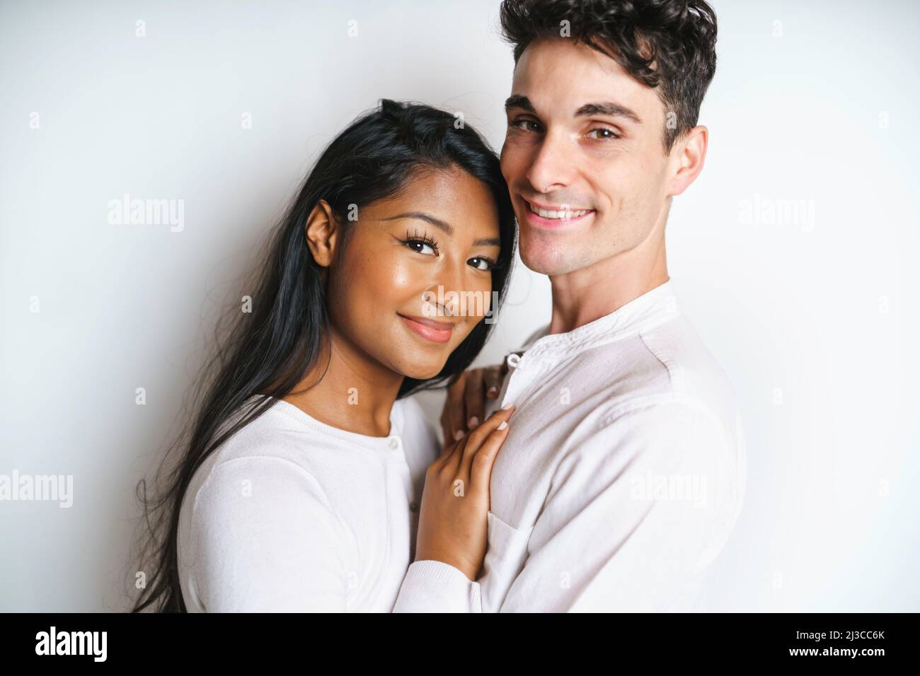 young couple standing together posing in studio white background Stock ...