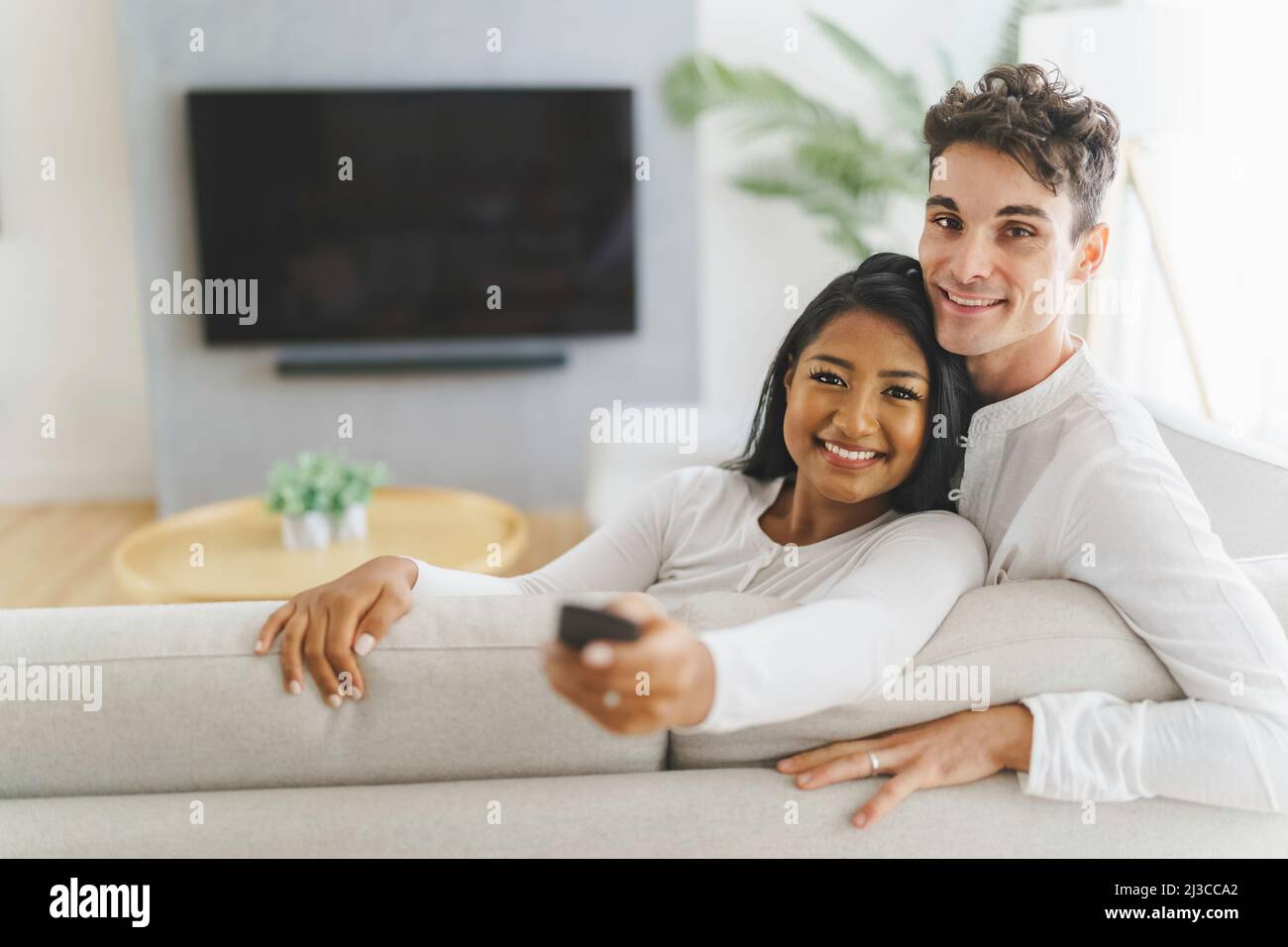 Couple watching tv in their living room at home Stock Photo - Alamy