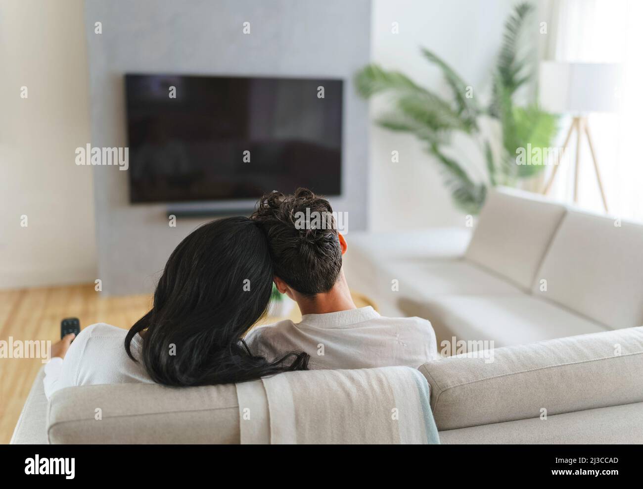 Couple watching tv in their living room at home Stock Photo - Alamy
