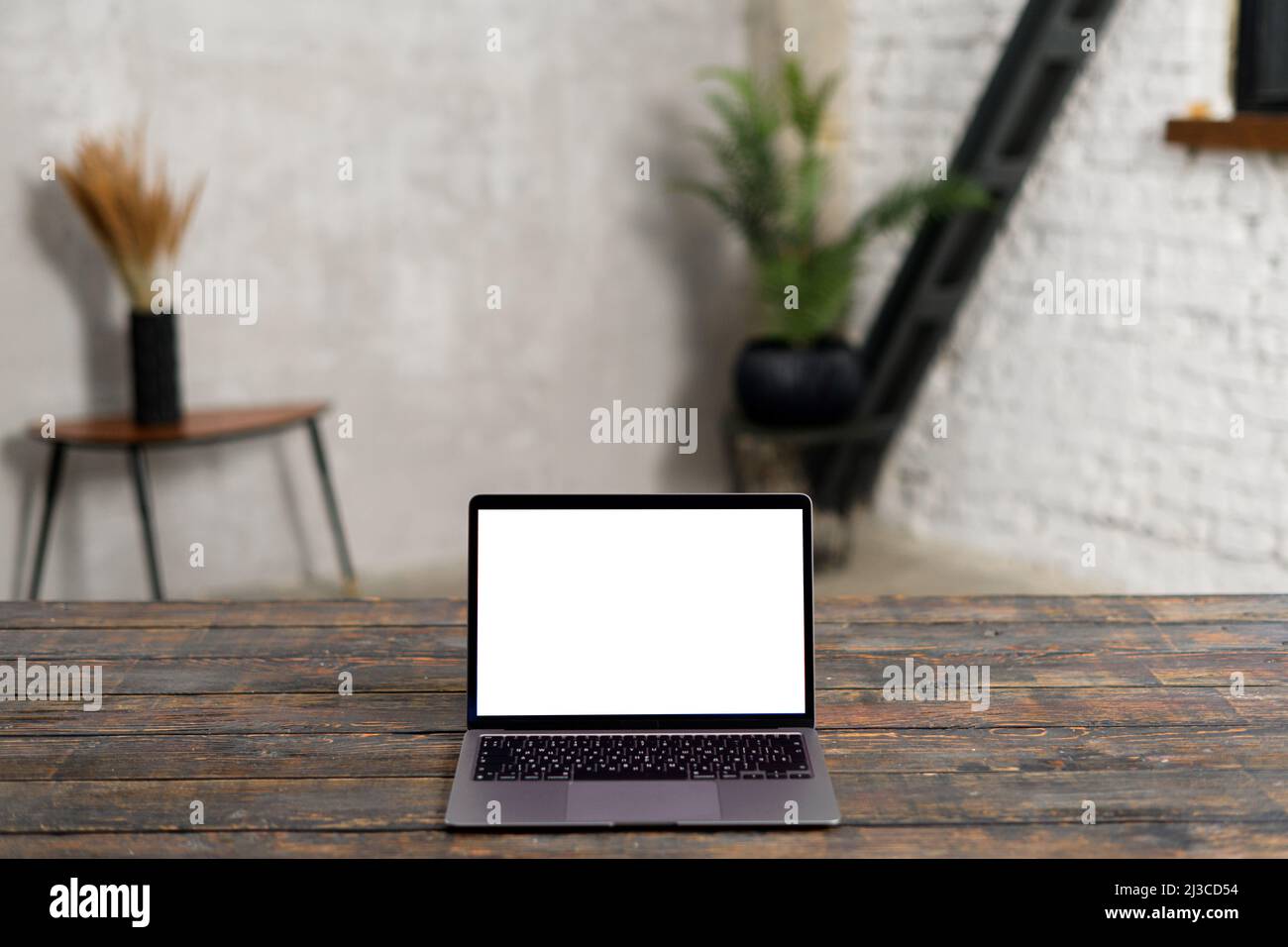 Modern laptop with empty screen on the wooden table with contemporary ...