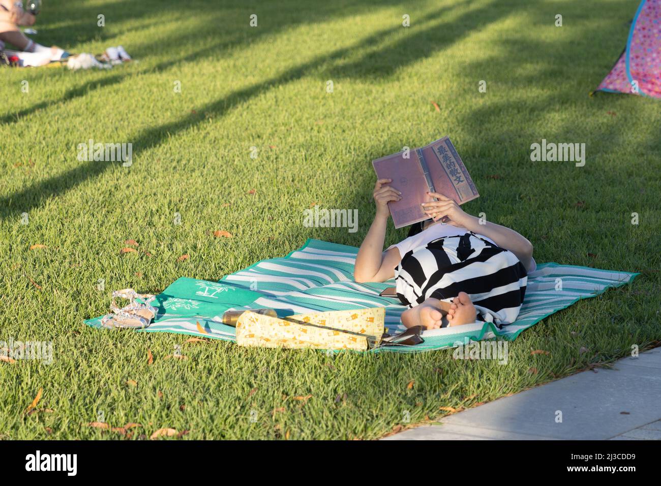29 5 2021 young lady relax at their camp in grass field , West Kowloon ...