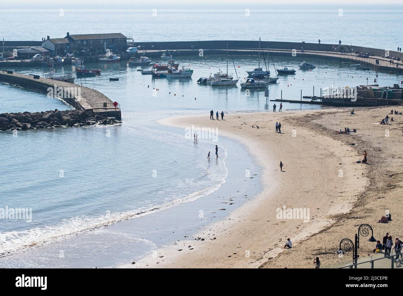Spring sunshine around the ancient stone pier, known as the Cobb ...