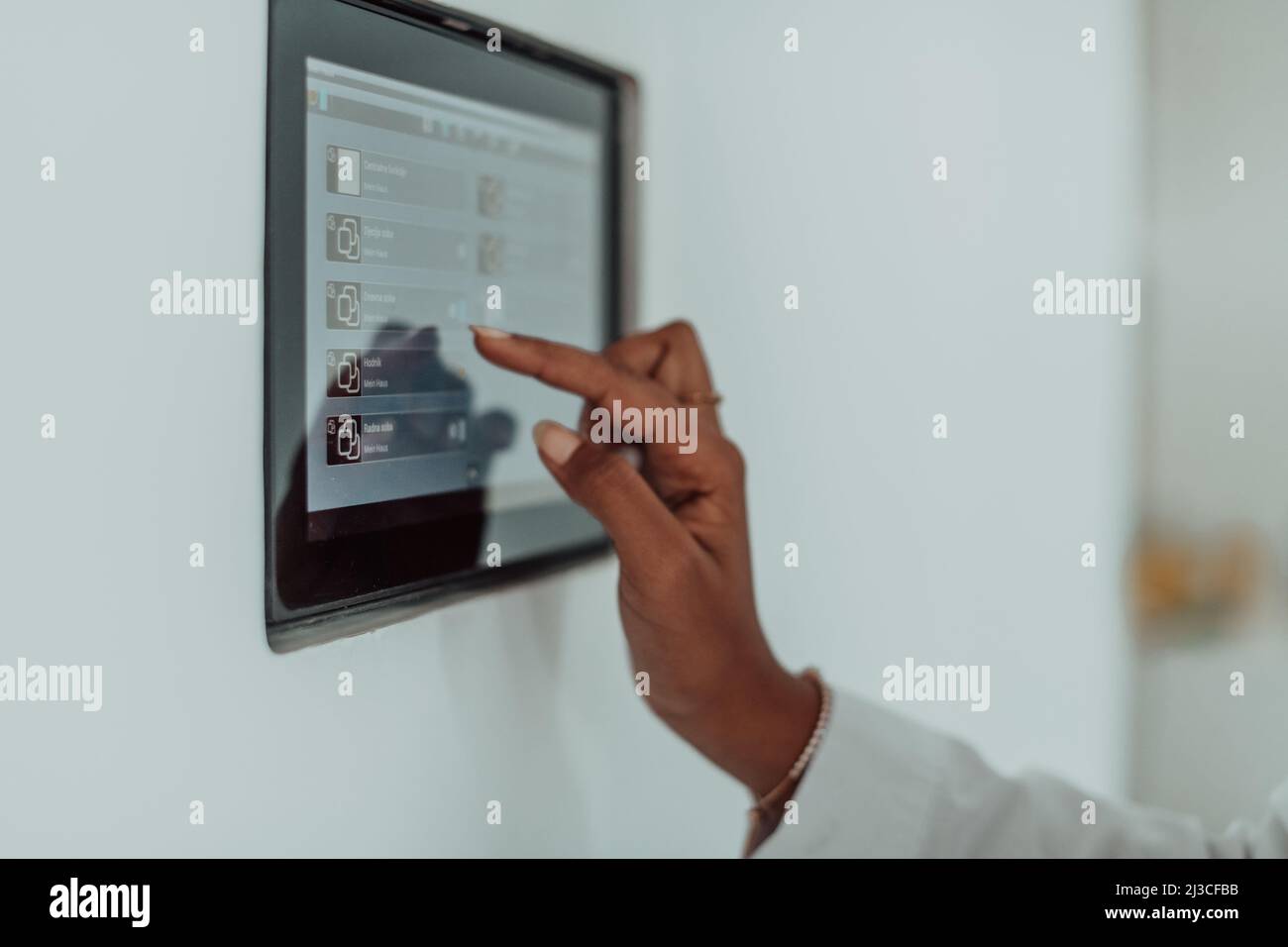 African woman using smart home screen control system Stock Photo - Alamy