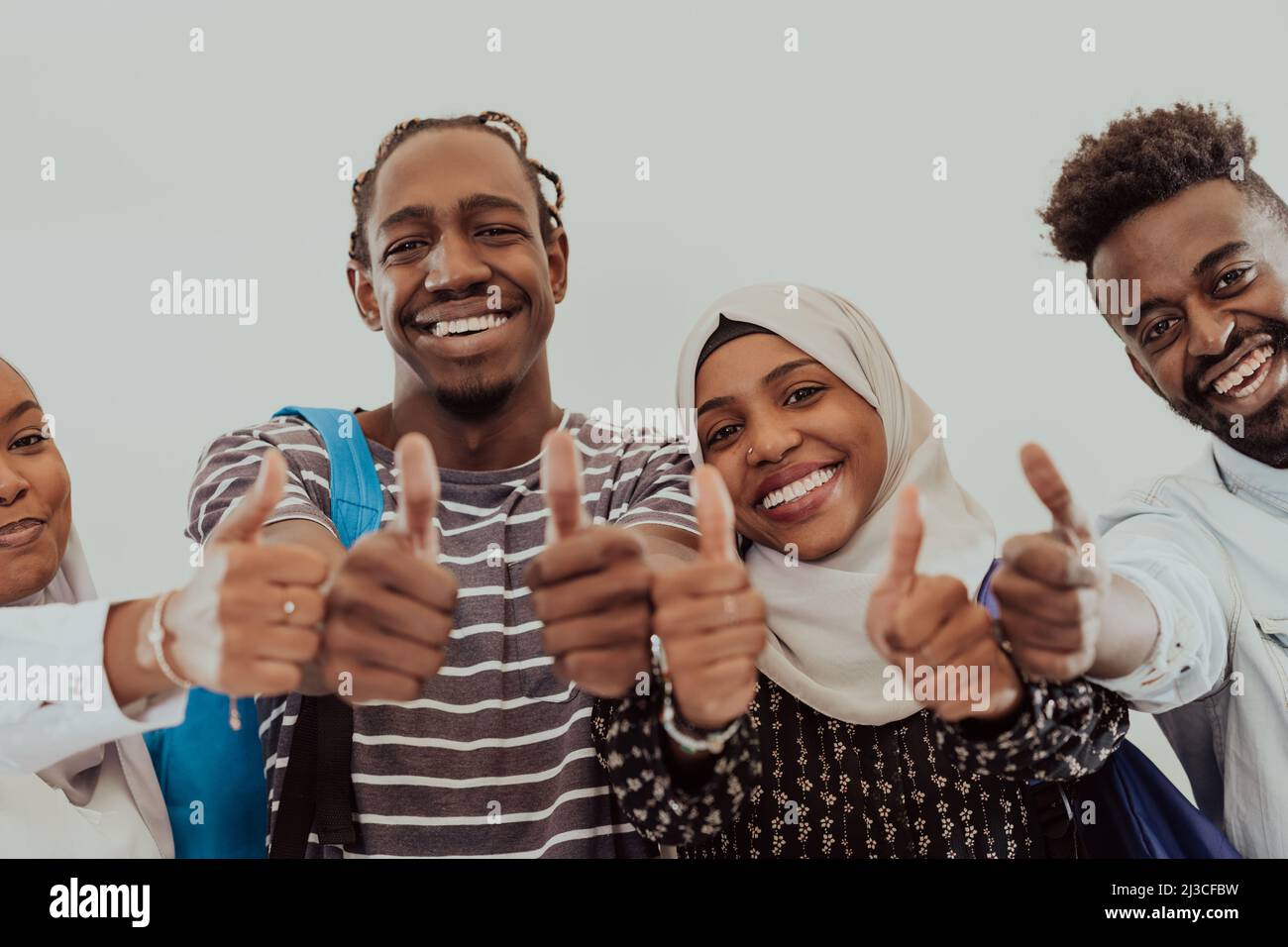 Group portrait of happy African students standing together against a ...