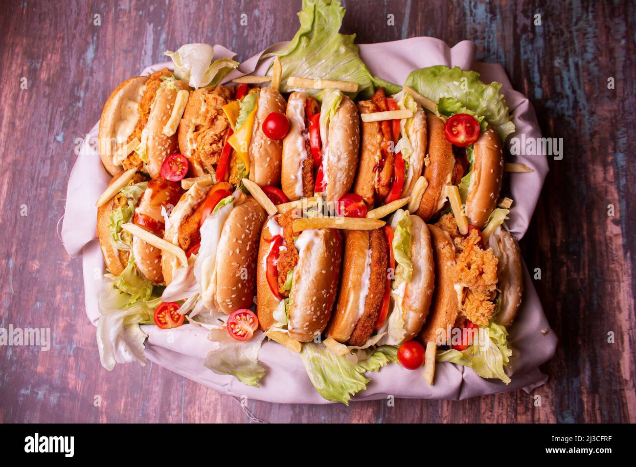 Different hamburgers seen from above with french fries in the middle of ...