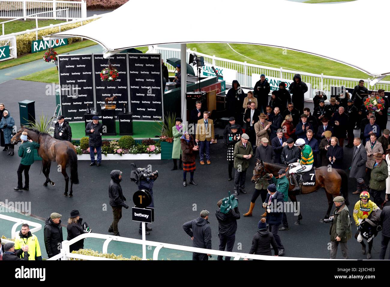 Epatante ridden by jockey Aidan Coleman is lead into the parade ring ...