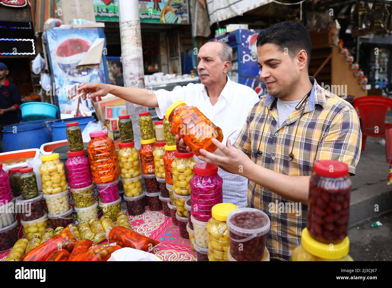 Cairo, Egypt. 7th Apr, 2022. People buy pickles at a market during the ...