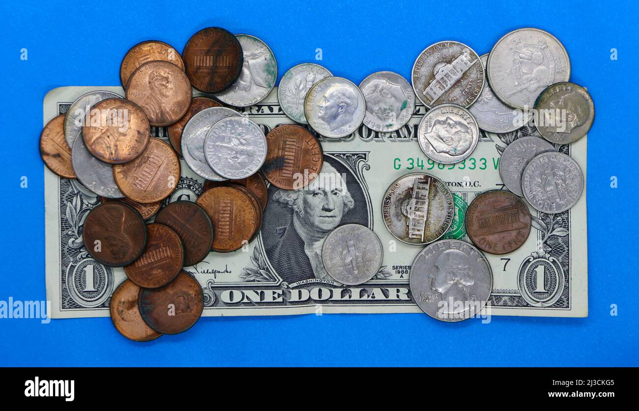 Photo of a One Dollar American bank note covered with old used coins 1 ...