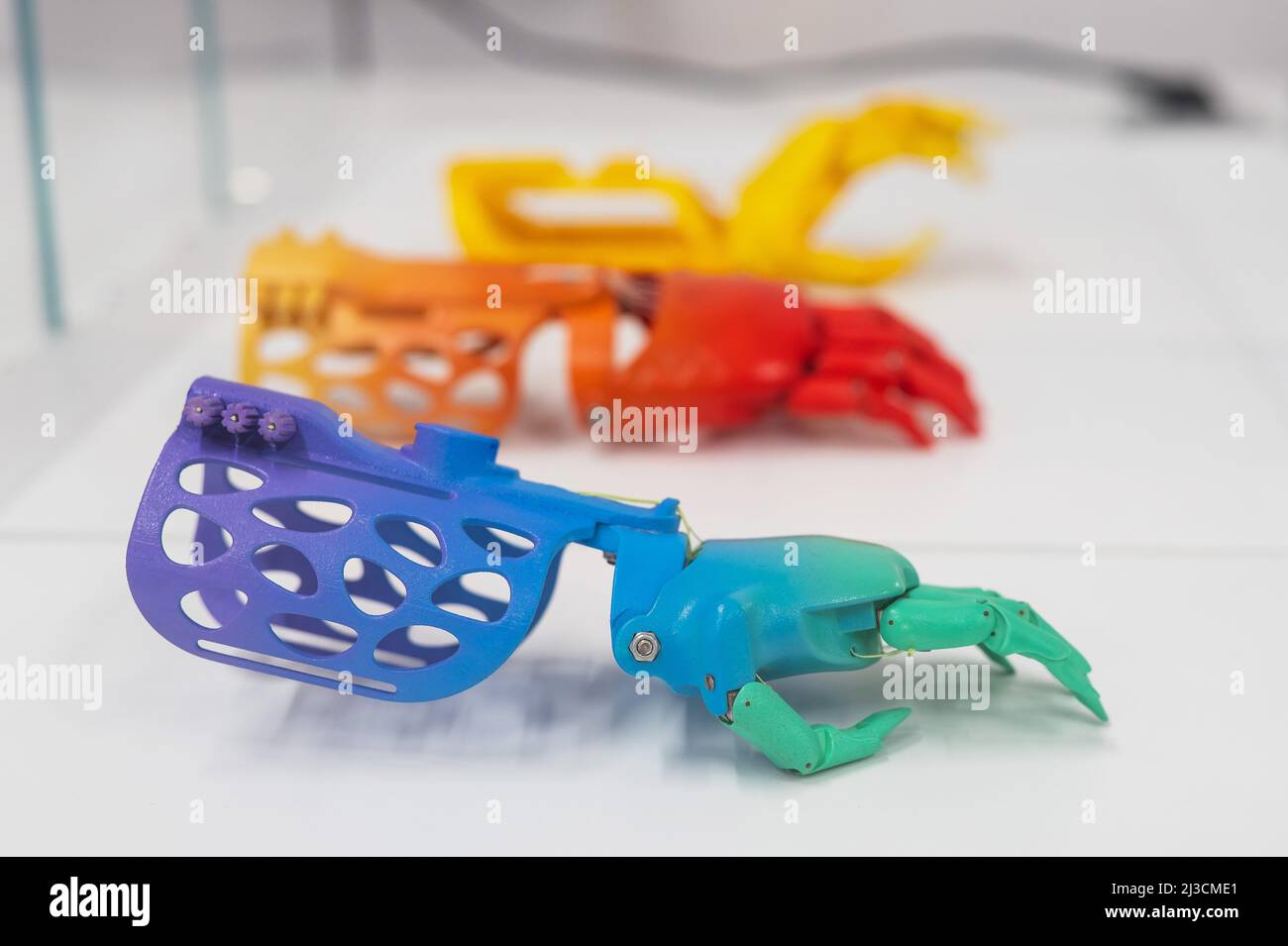 Samples of multi-colored children's prosthetic hands made of 3D plastic ...