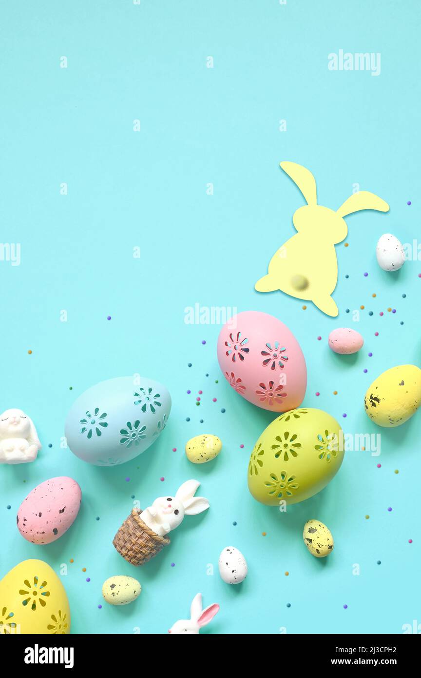 Easter composition. Easter eggs and easter bunny on pastel blue ...