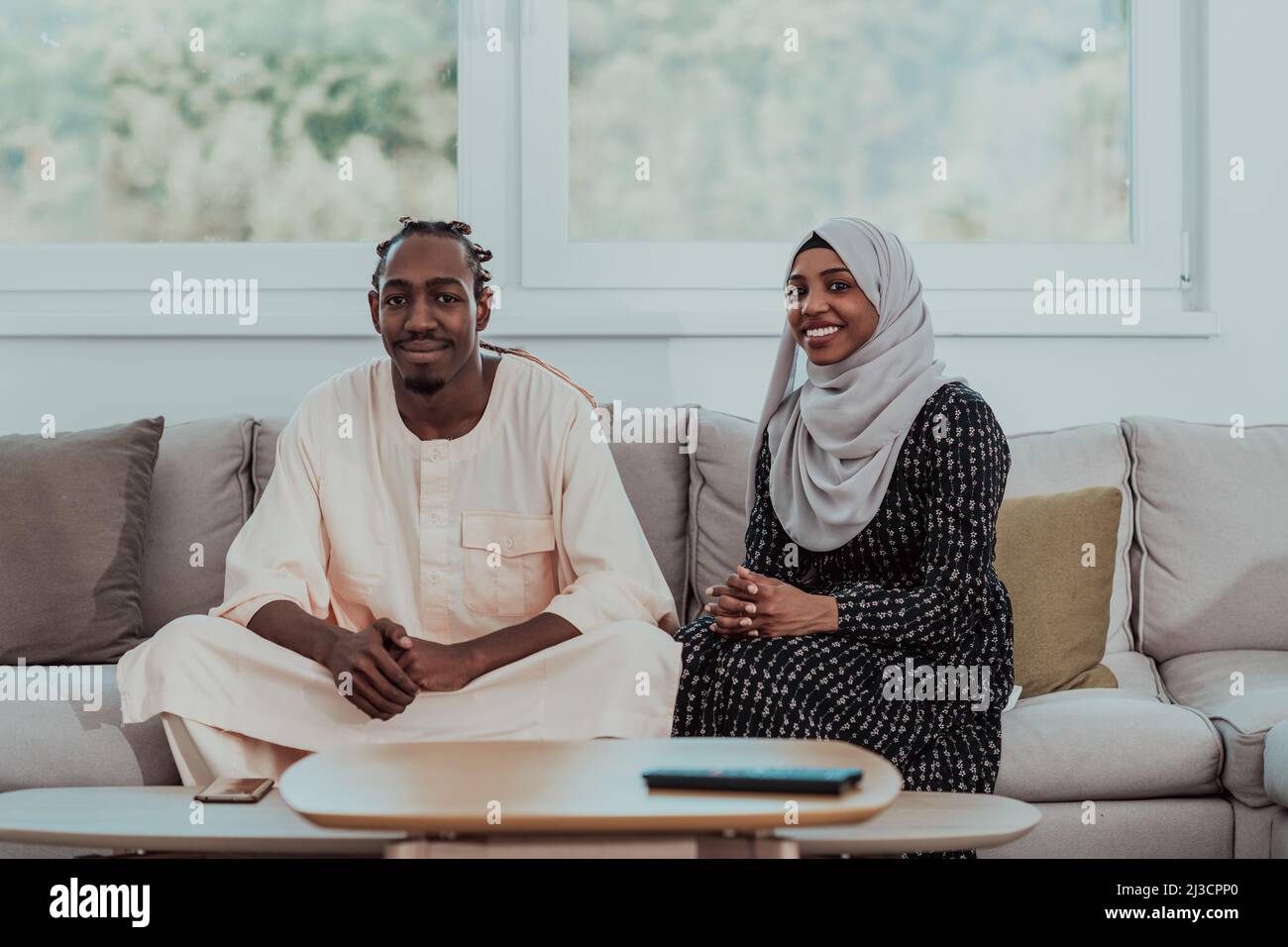 African Muslim couple at home in Ramadan reading Quran holly Islam book ...