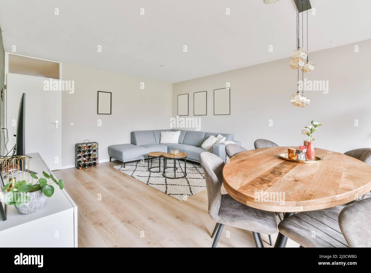 Interior of contemporary open space flat in pastel colors with dining ...