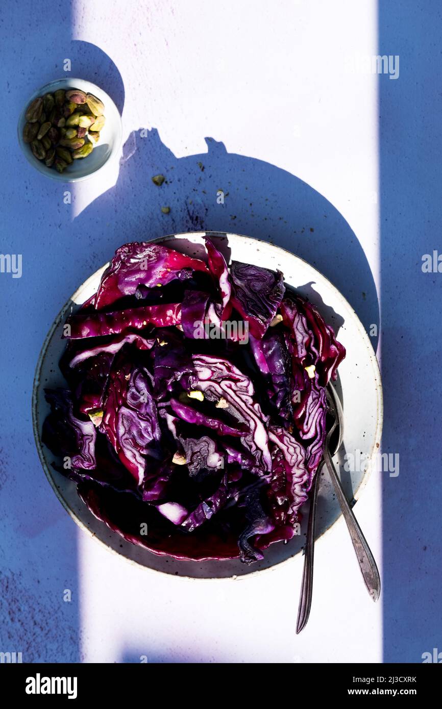 Top view of fresh vegan salad made of ripe red cabbage and served in ...