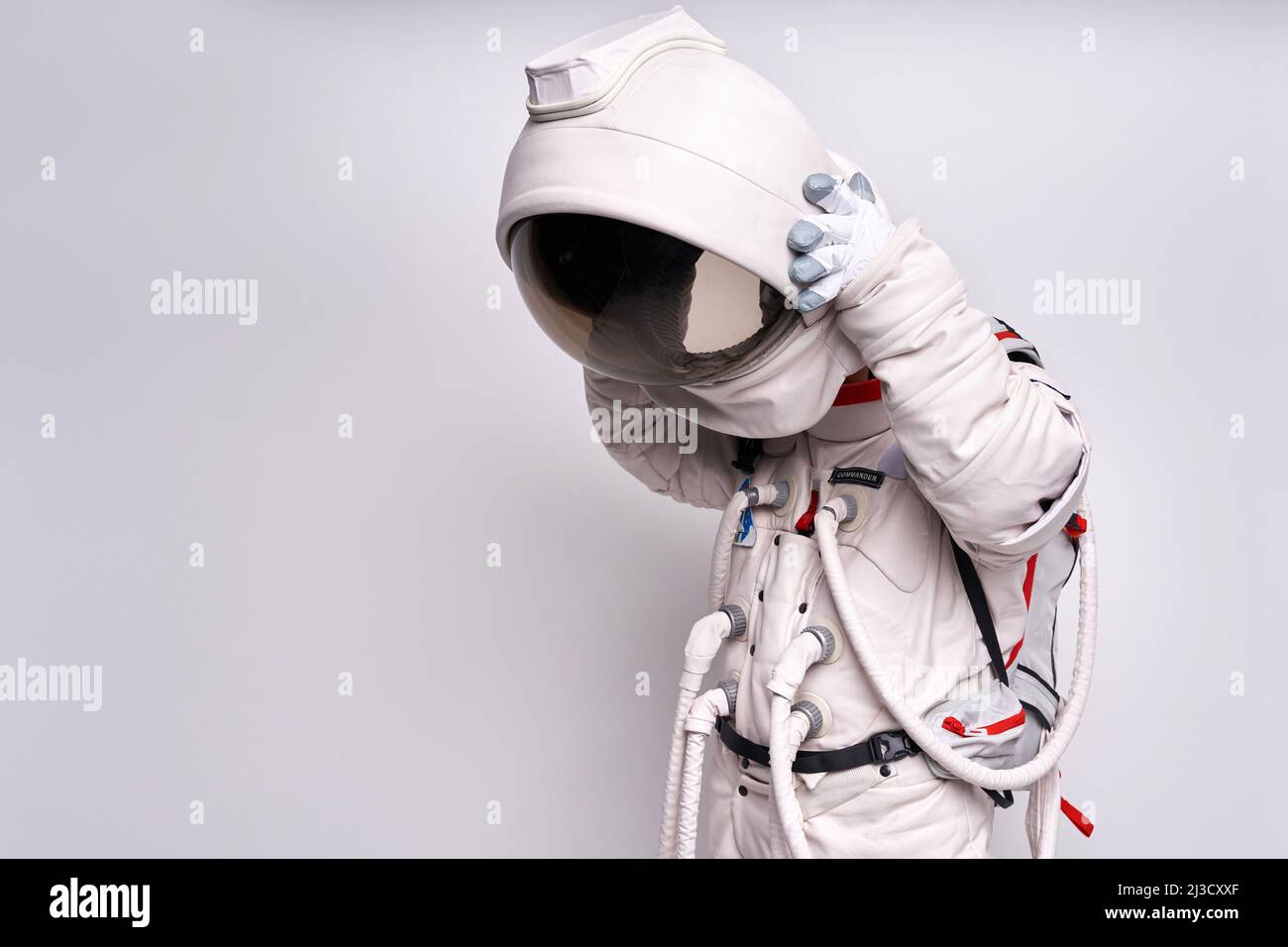 Side view of unrecognizable astronaut in spacesuit taking off ...