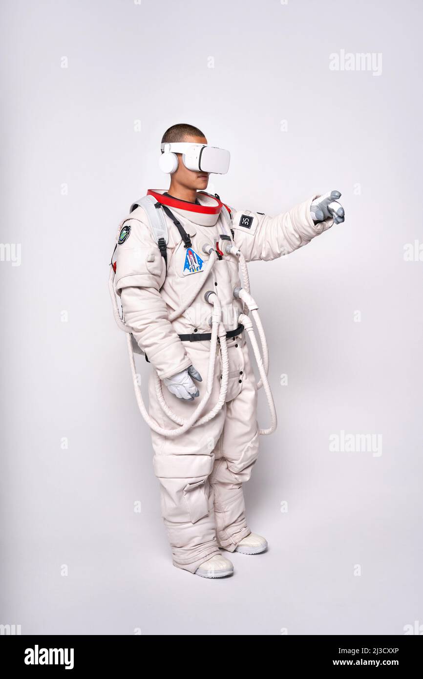 Colombian male cosmonaut in uniform interacting with virtual cosmos in ...