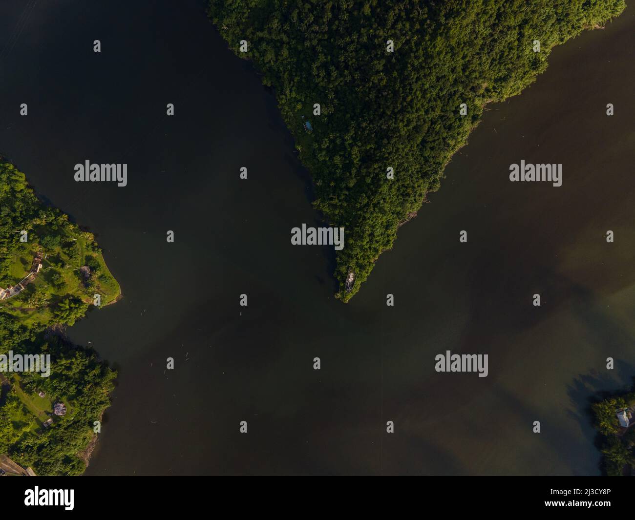 Drone view of calm winding lake streaming through hilly valley covered ...