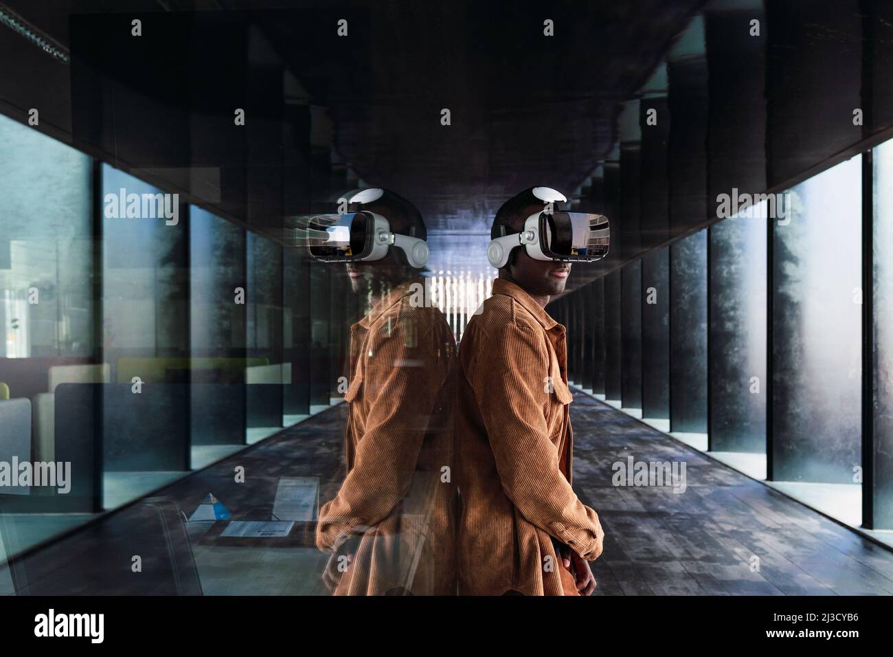 Side view of African American male in modern VR goggles standing ...