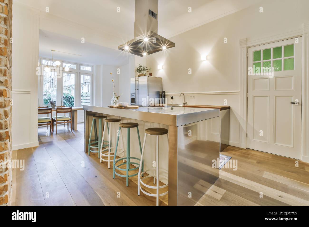 Metal counter placed in spacious stylish kitchen with modern appliances ...