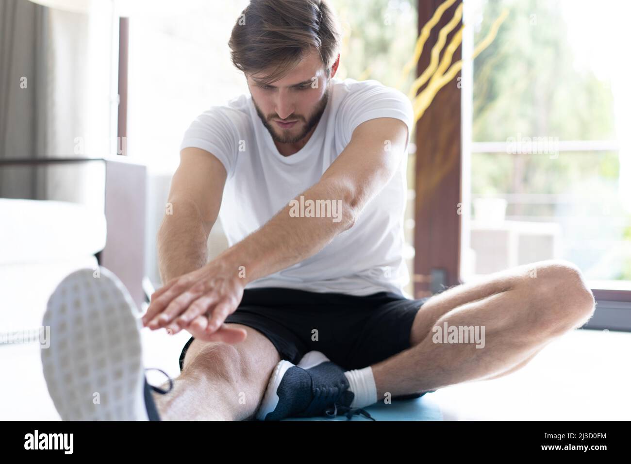Portrait of man doing workout exercise indoors at home Stock Photo - Alamy