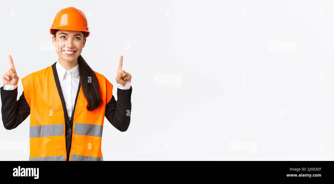 Building, construction and industrial concept. Satisfied successful female asian saleswoman ...