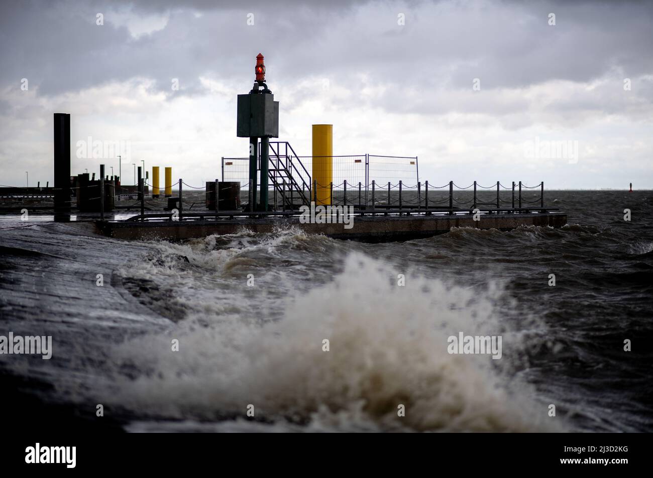 Wilhelmshaven, Germany. 07th Apr, 2022. Waves wash over a walkway in ...
