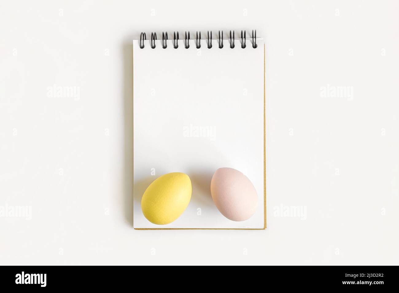 Notebook with Easter Eggs. Spiral notepad on spring white background ...