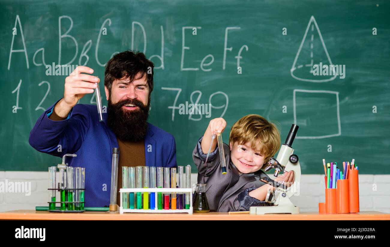 teacher man with little boy. School education. science camp. Chemistry ...