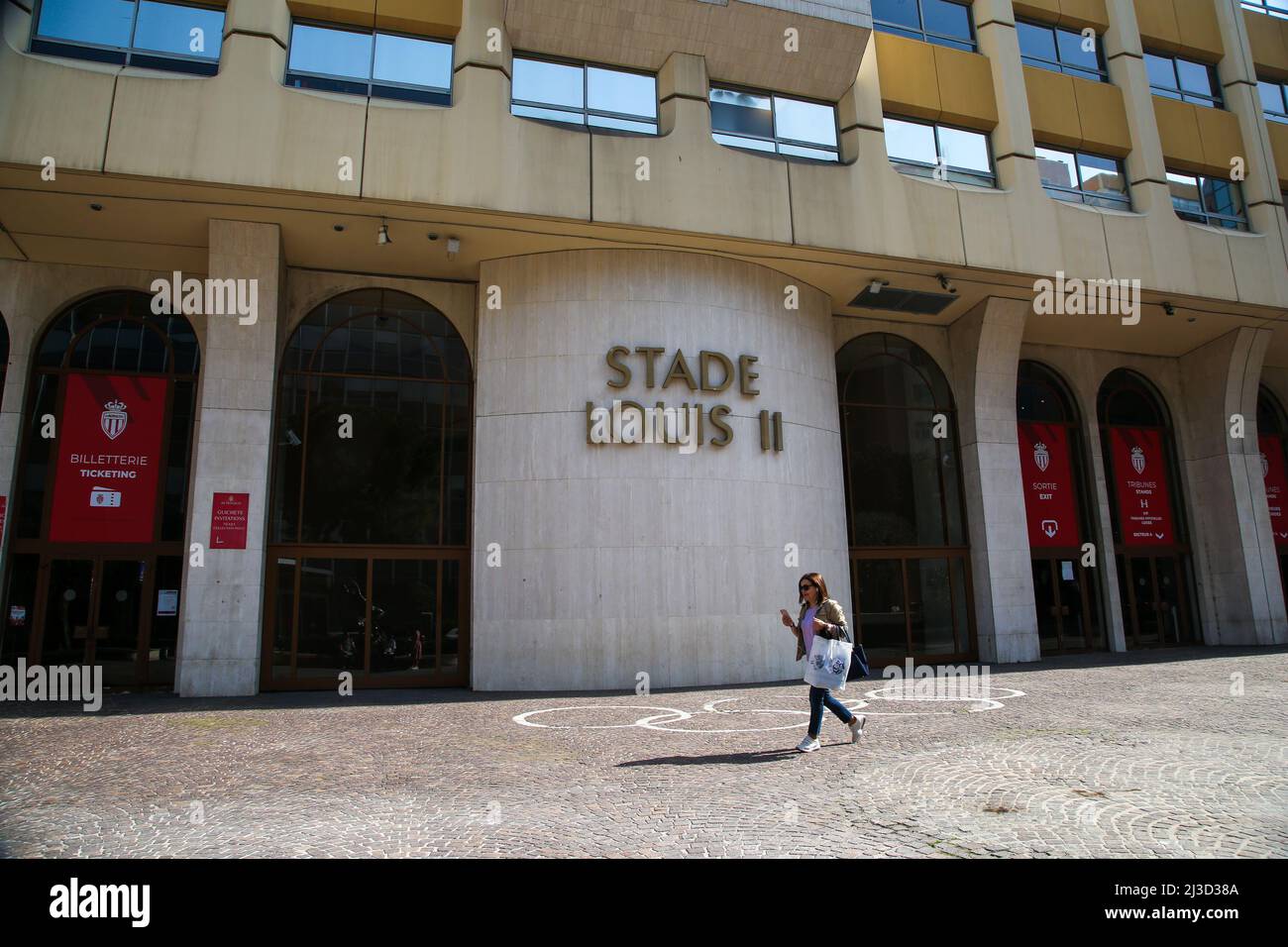 A woman walks past Stade Louis II stadium, which is located in the ...