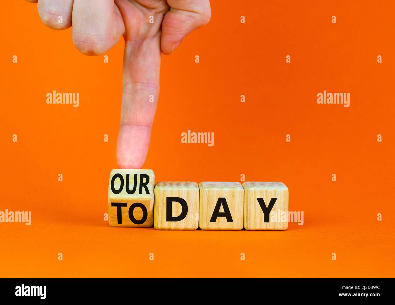Today is our day symbol. Businessman turns the wooden cube and changes ...