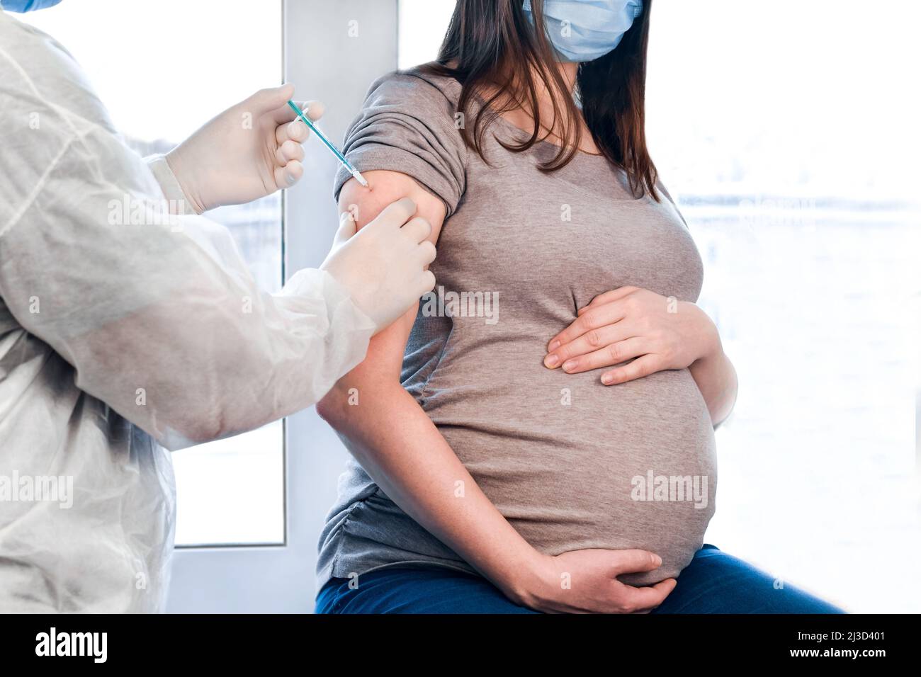 Pregnant Vaccination. Pregnant Woman In Face Mask Getting Vaccinated in ...