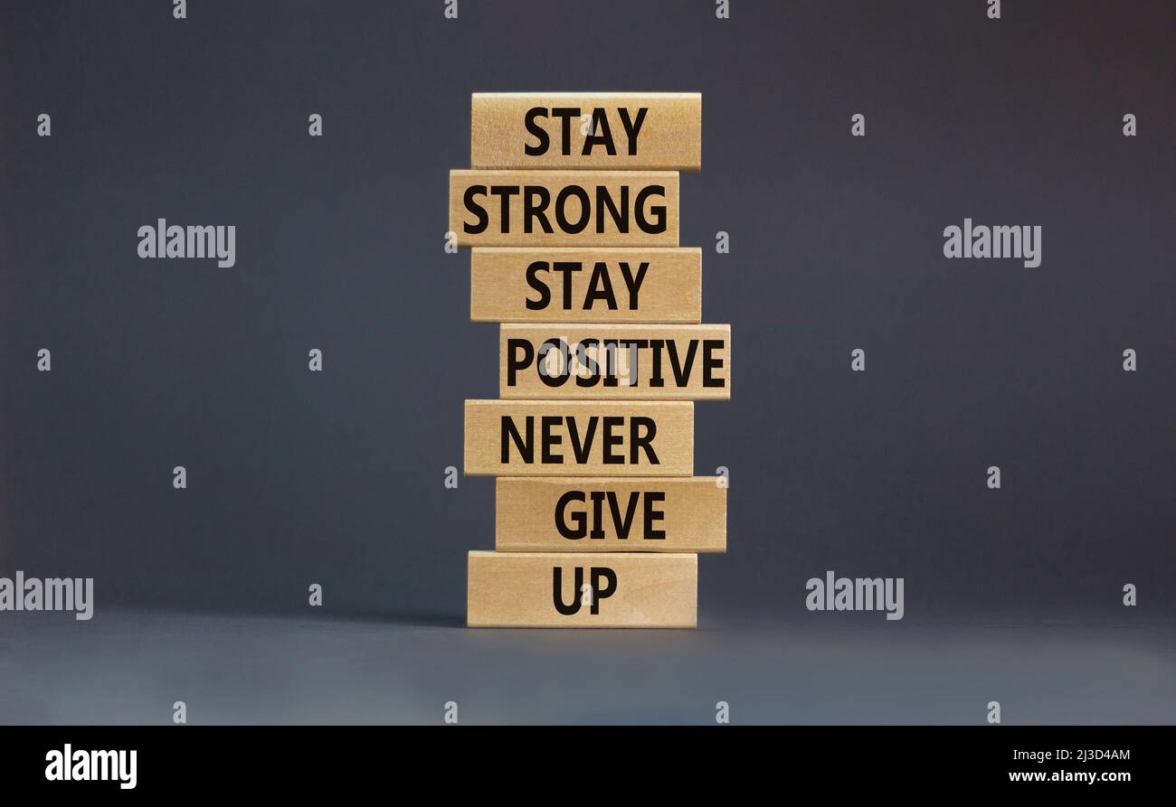 Never give up symbol. Wooden blocks with concept words Stay strong stay ...