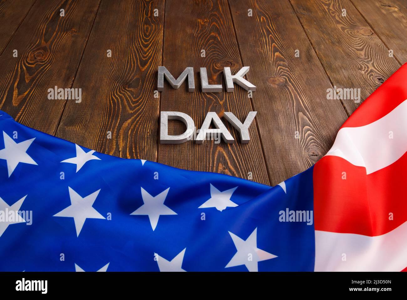 the word MLK day laid with silver metal letters on wooden surface with ...