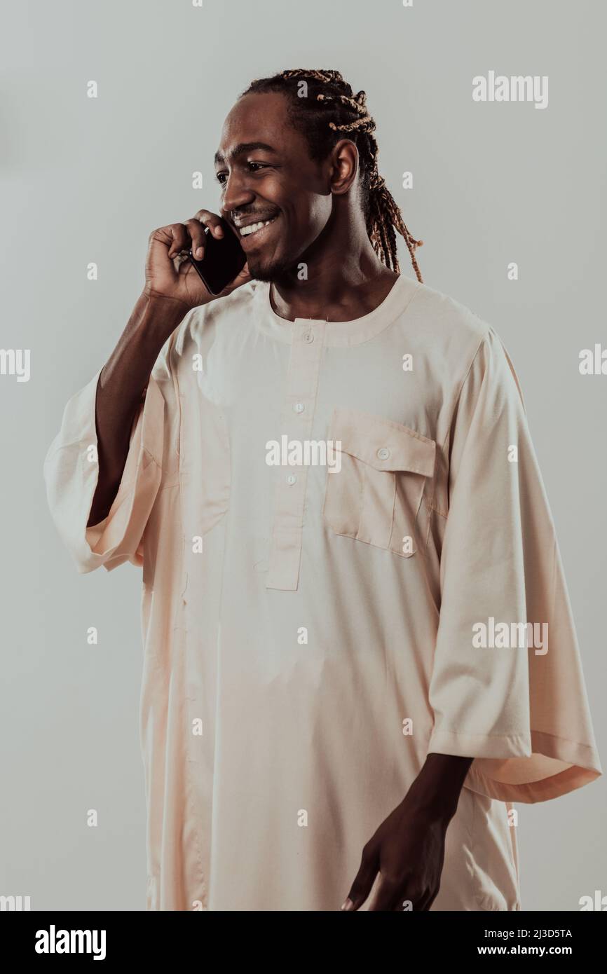 African man using smartphone and wearing traditional Sudan clothes ...