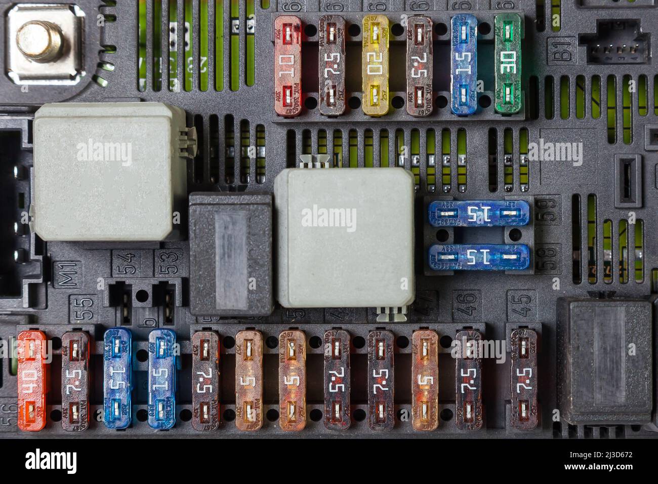 Automotive fuses on a black panel with holders and multi-colored ...