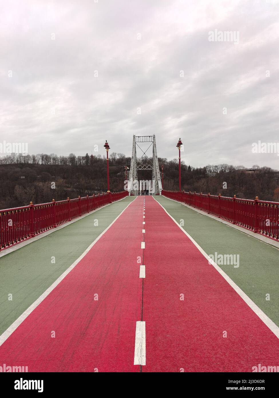 Asphalt divided road of red color on the bridge in perspective ...