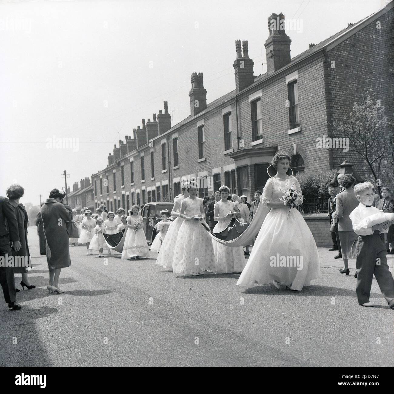1961, historical, May Day procession, two young girls in long dresses ...