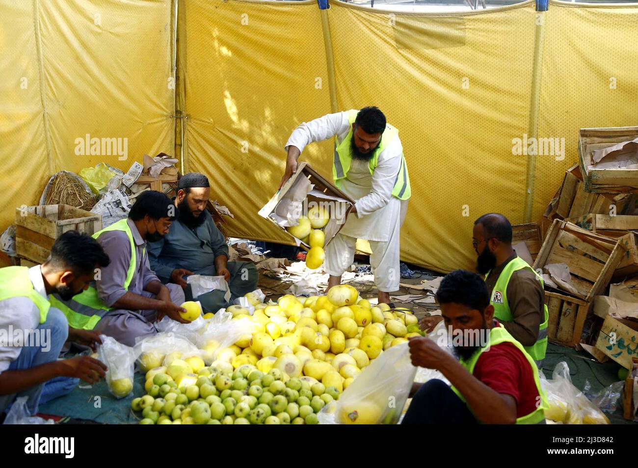 Volunteers busy in packing of relief goods for distributes relief goods ...