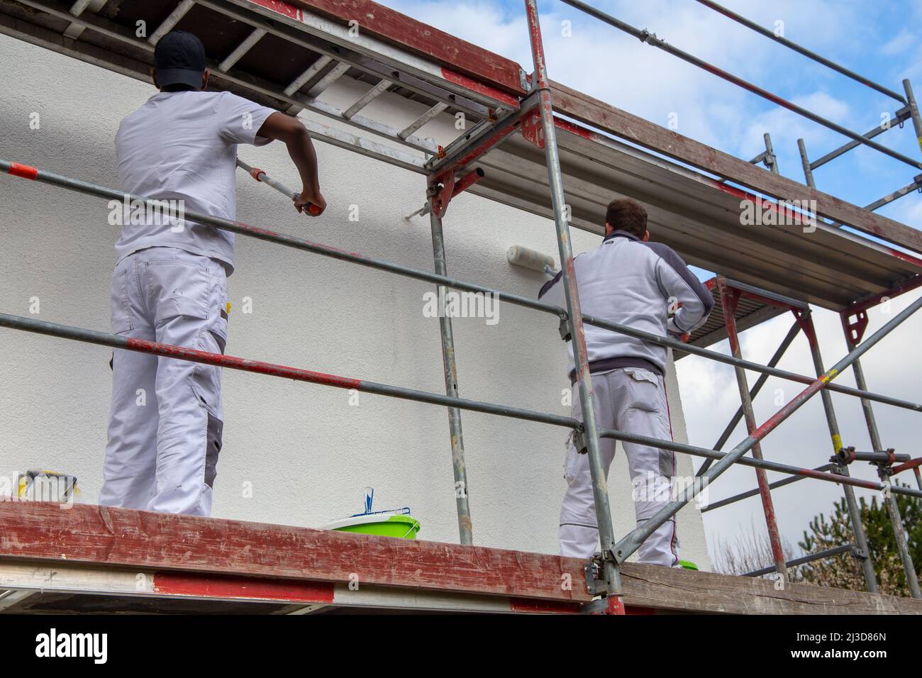 Painter painting the facade of a new residential building Stock Photo ...