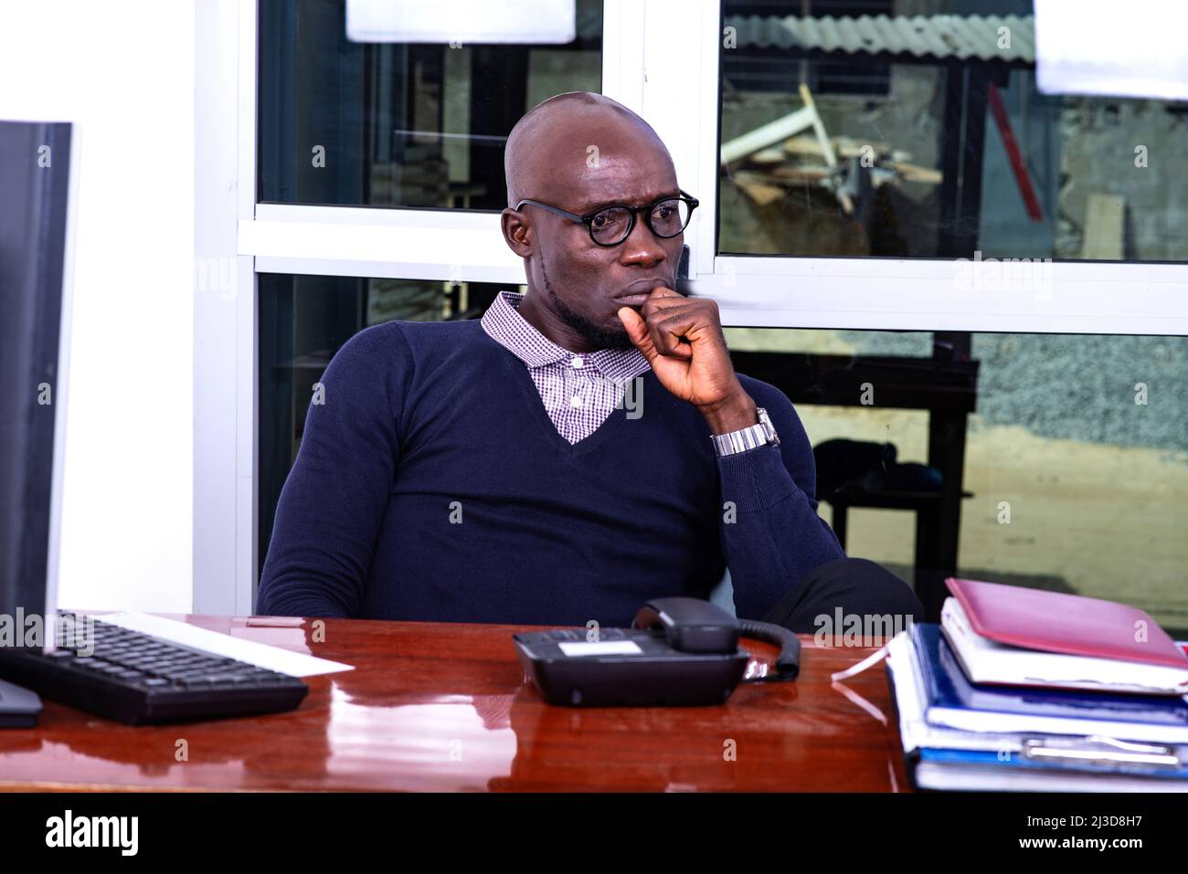 adult businessman thinking about something with hand over mouth in the ...