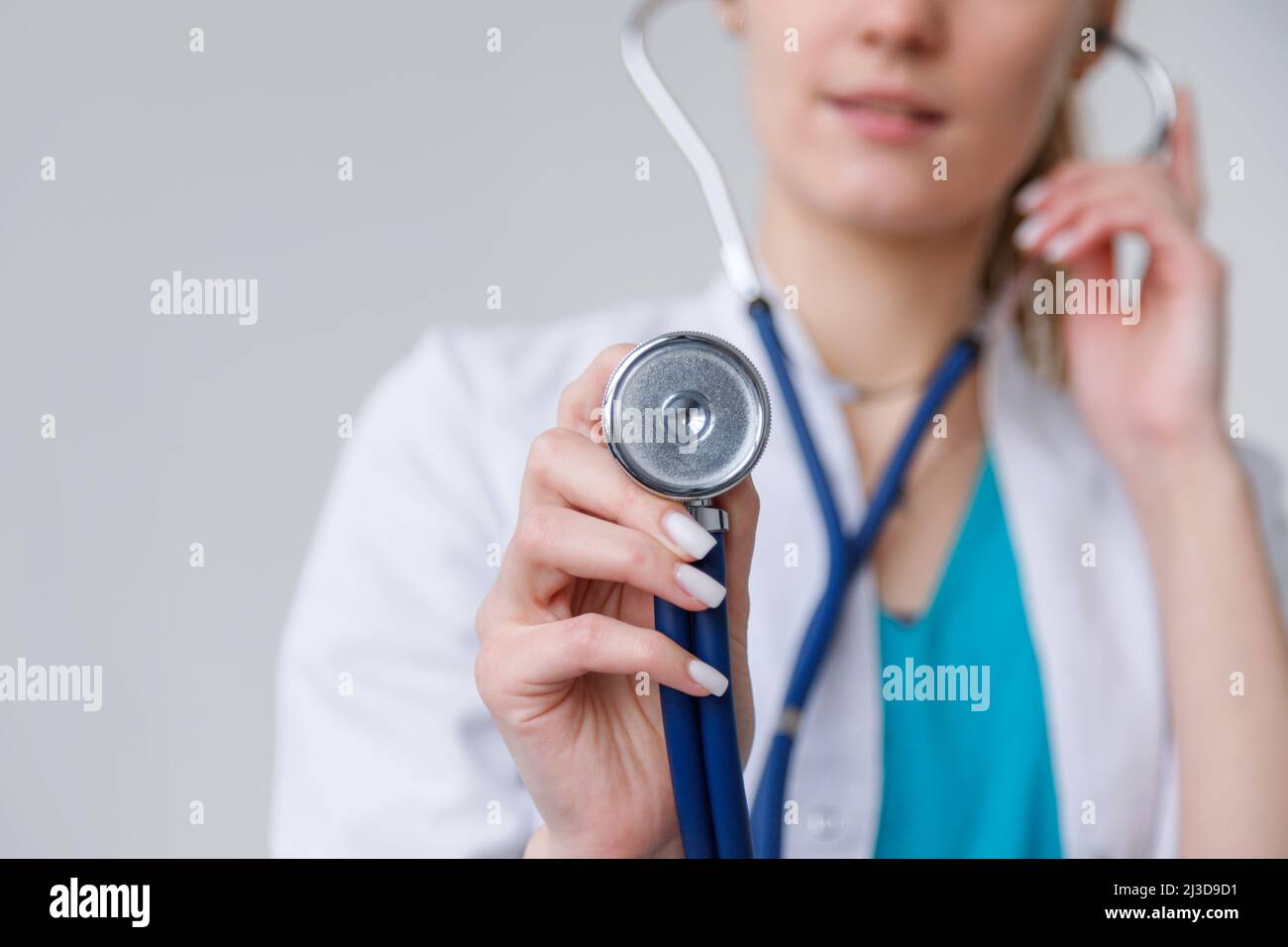 Closeup shot of stethoscope in female doctor hand ready to listen ...