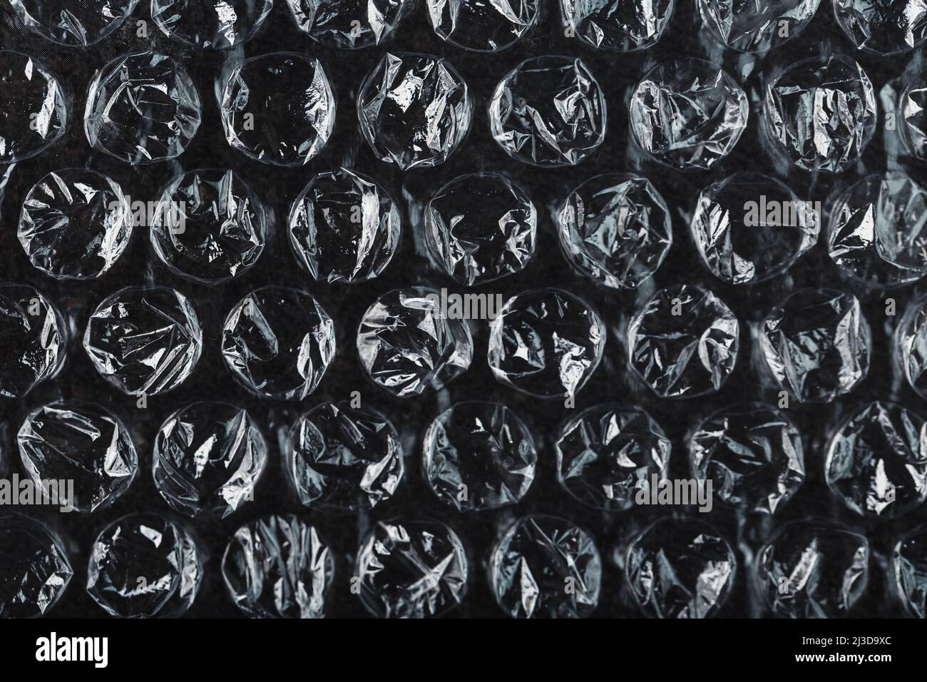 Packing bubble wrap for parcels on a Black background in full screen ...