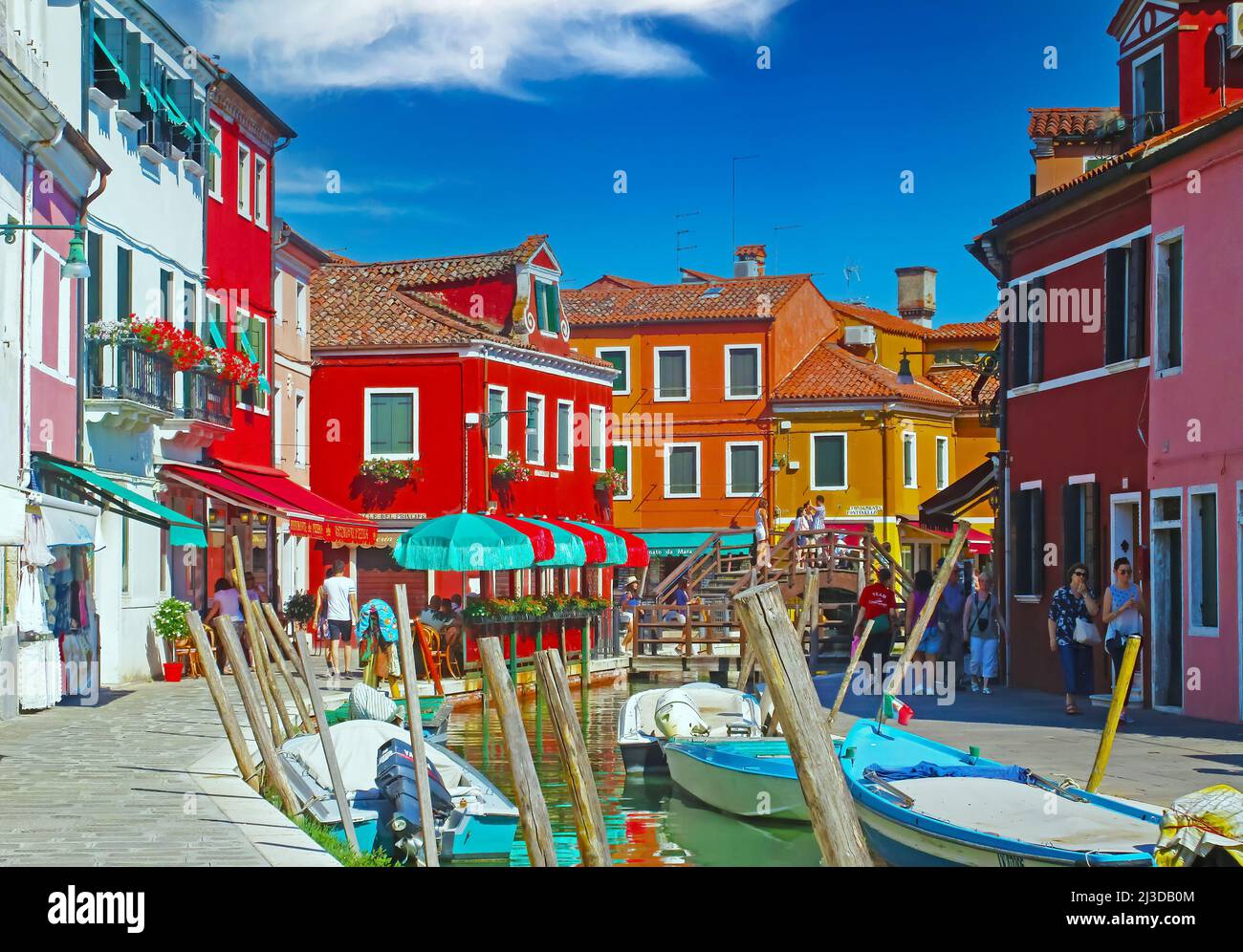 Venice (Burano), Italy - May 9. 2019: View over water canal with boats ...