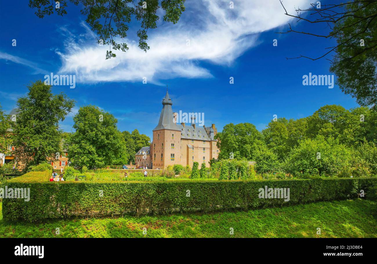 View over garden park hedge on medieval dutch water castle from 14th ...
