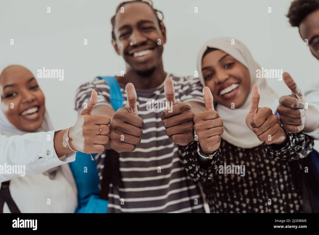 Group portrait of happy African students standing together against a ...