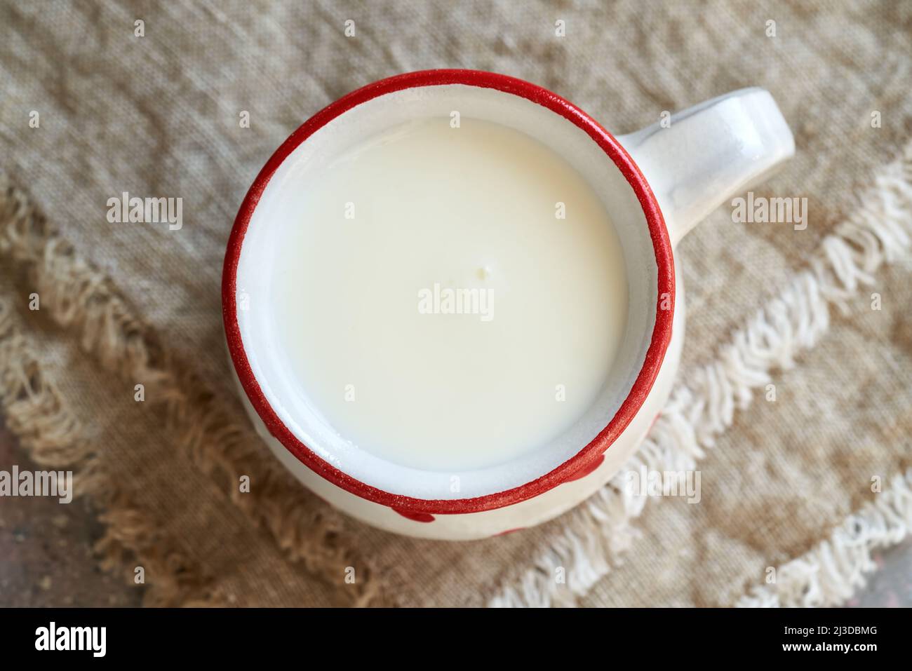 Kefir drink in a red and white cup, top view Stock Photo - Alamy