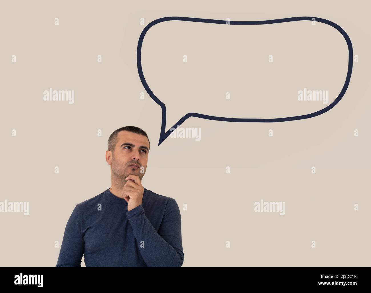 Pensive brown skinned man standing. Speech bubble for copy space text ...