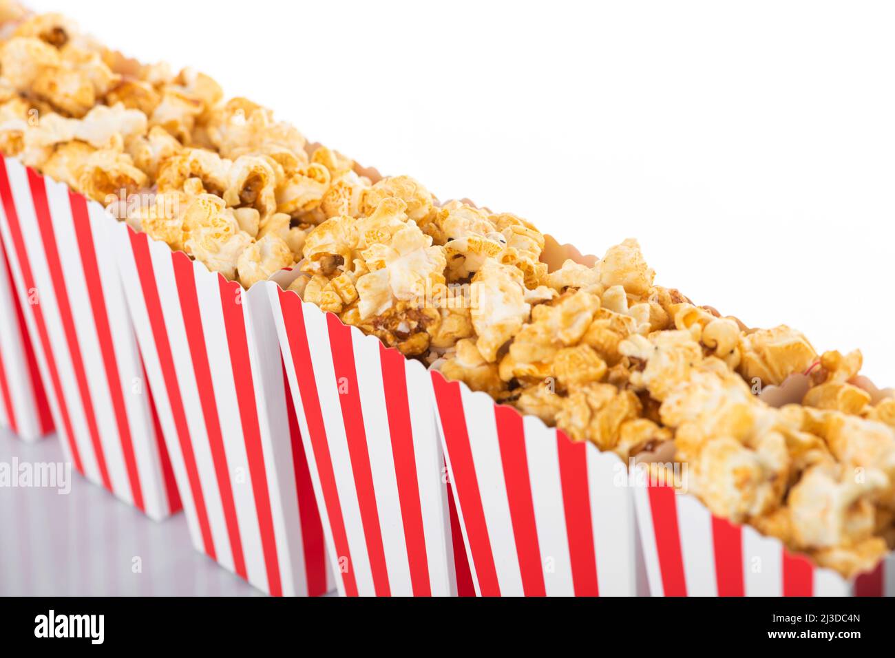 Popcorn boxes with white and red stripes full of sweet with caramel ...