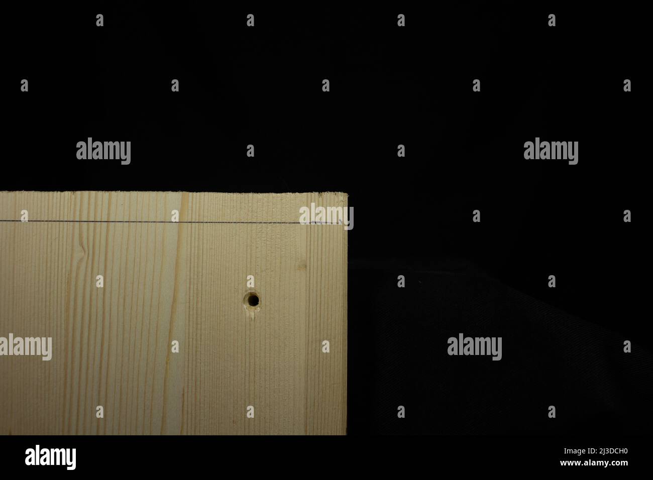 cut piece of soft pine with pencil mark and screw hole isolated on a ...