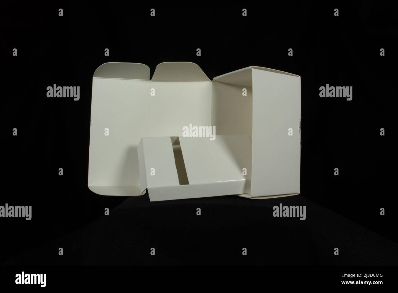 open white box with closing tabs and with insert in shadow isolated on ...